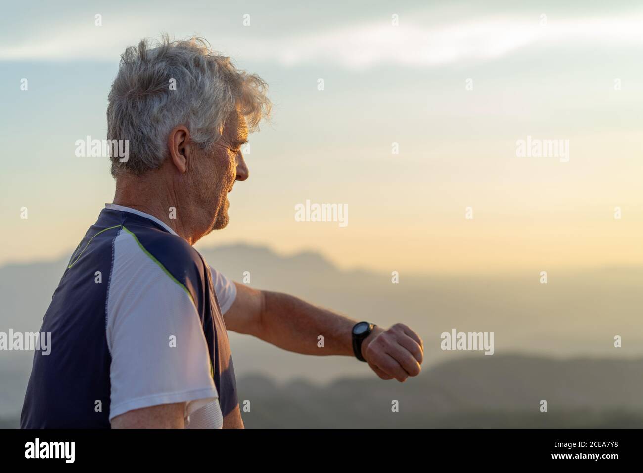 Elderly man checking wristwatch Stock Photo - Alamy