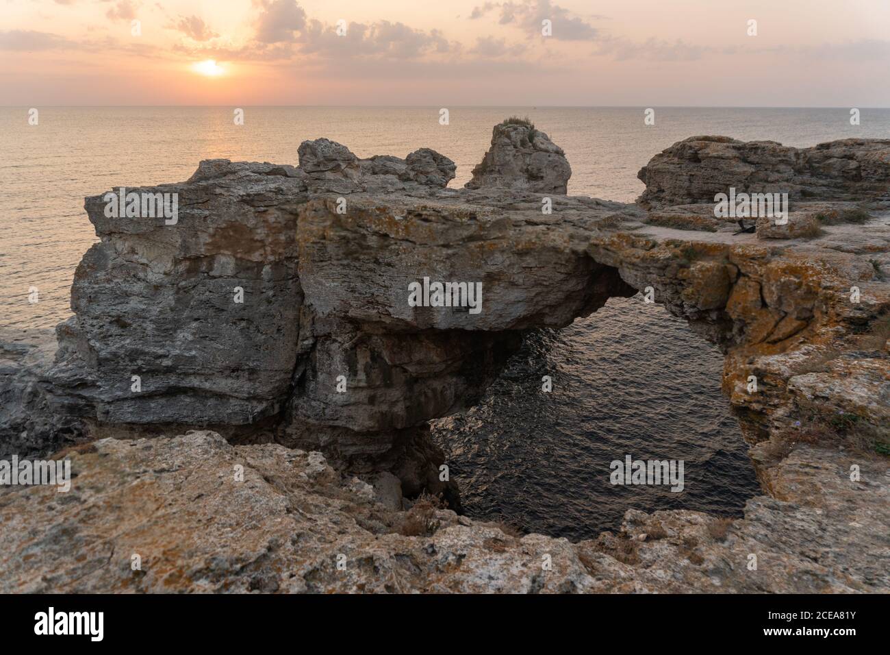 Amazing rough rocks standing calm sea water beautiful sunset tyulenovo ...