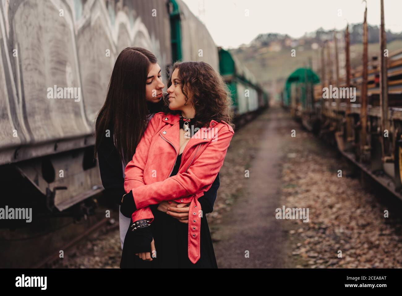 Long haired man hugging and kissing Woman near train Stock Photo - Alamy