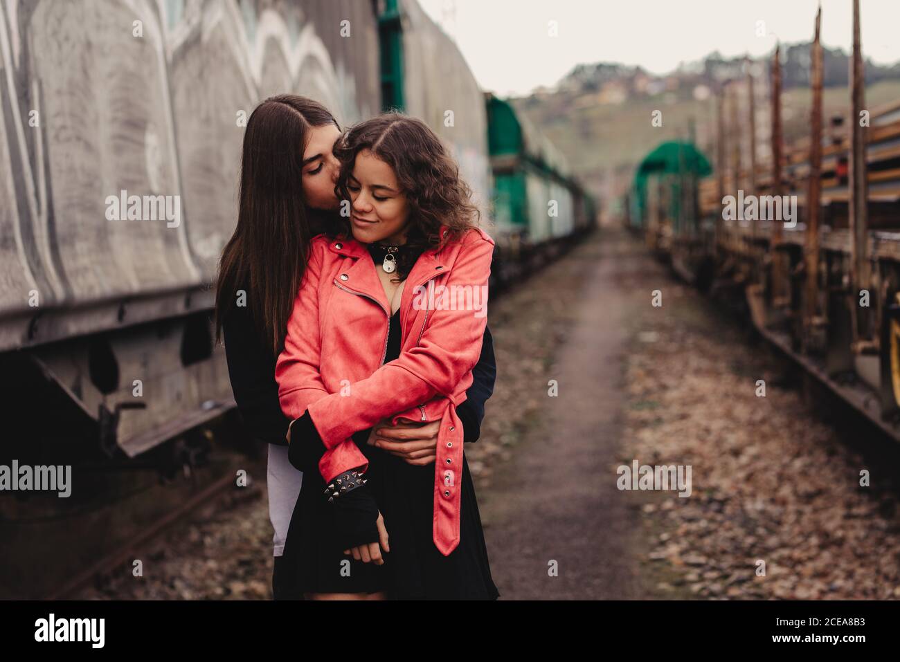 Long haired man hugging and kissing Woman near train Stock Photo - Alamy