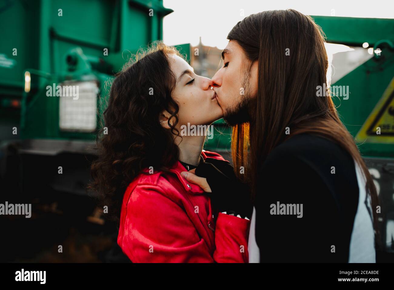 Long haired man hugging and kissing Woman near train Stock Photo - Alamy