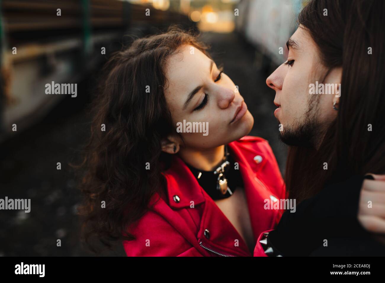 Long haired man hugging and kissing Woman near train Stock Photo - Alamy