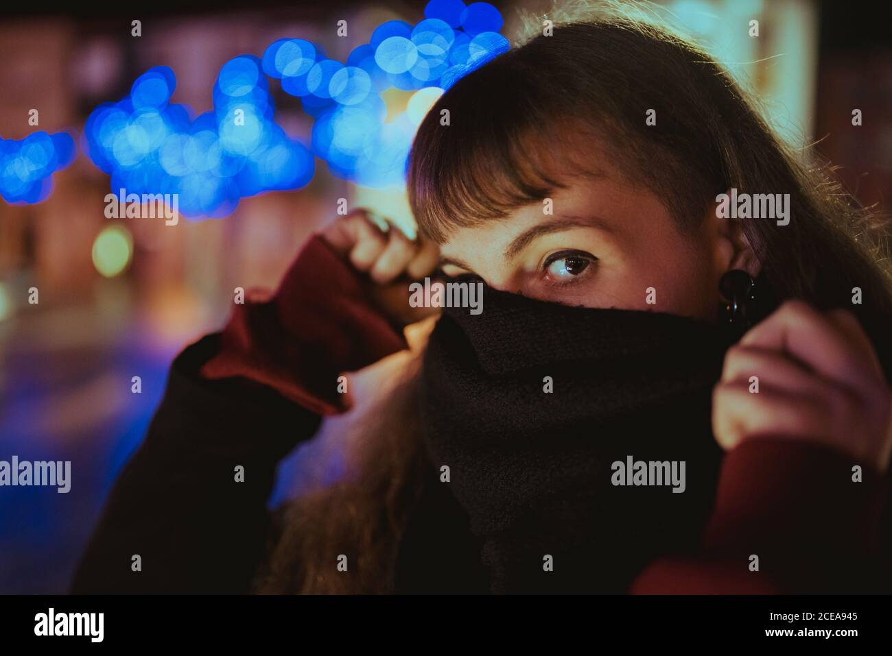 Young Woman closing face by cloth on street Stock Photo - Alamy