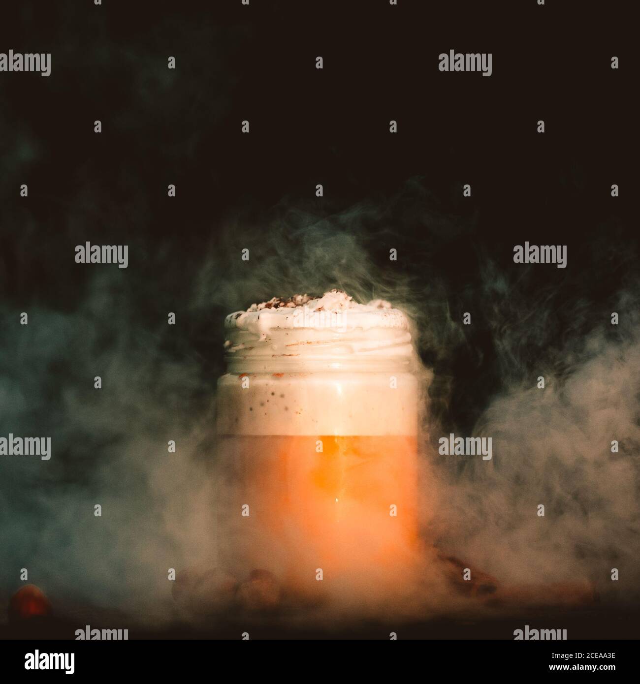 Thin white fume spreading over tabletop with jar of fresh coffee and ...