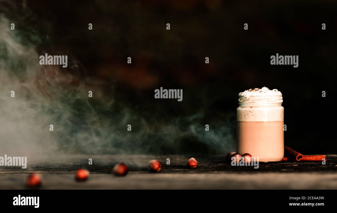 Thin white fume spreading over tabletop with jar of fresh coffee and ...