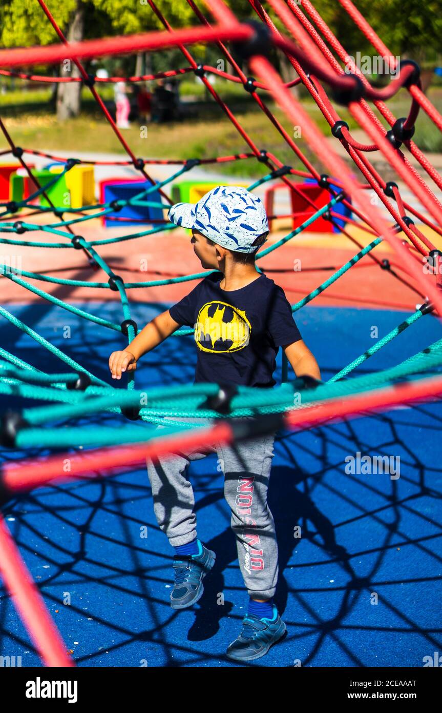 POZNAN, POLAND - Aug 29, 2020: Young boy with a Batman shirt climbing ...