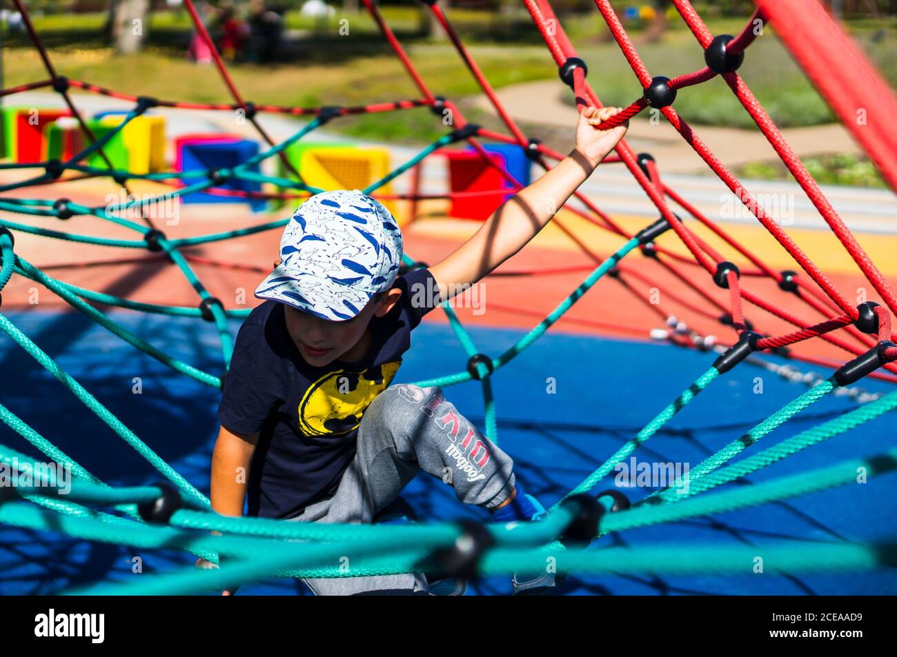 POZNAN, POLAND - Aug 29, 2020: Young boy with a Batman shirt climbing ...
