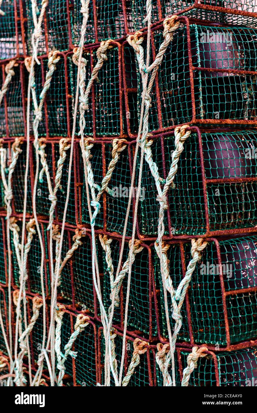 Pile of modern fishing cages with ropes on sunny day in Puerto llanes ...