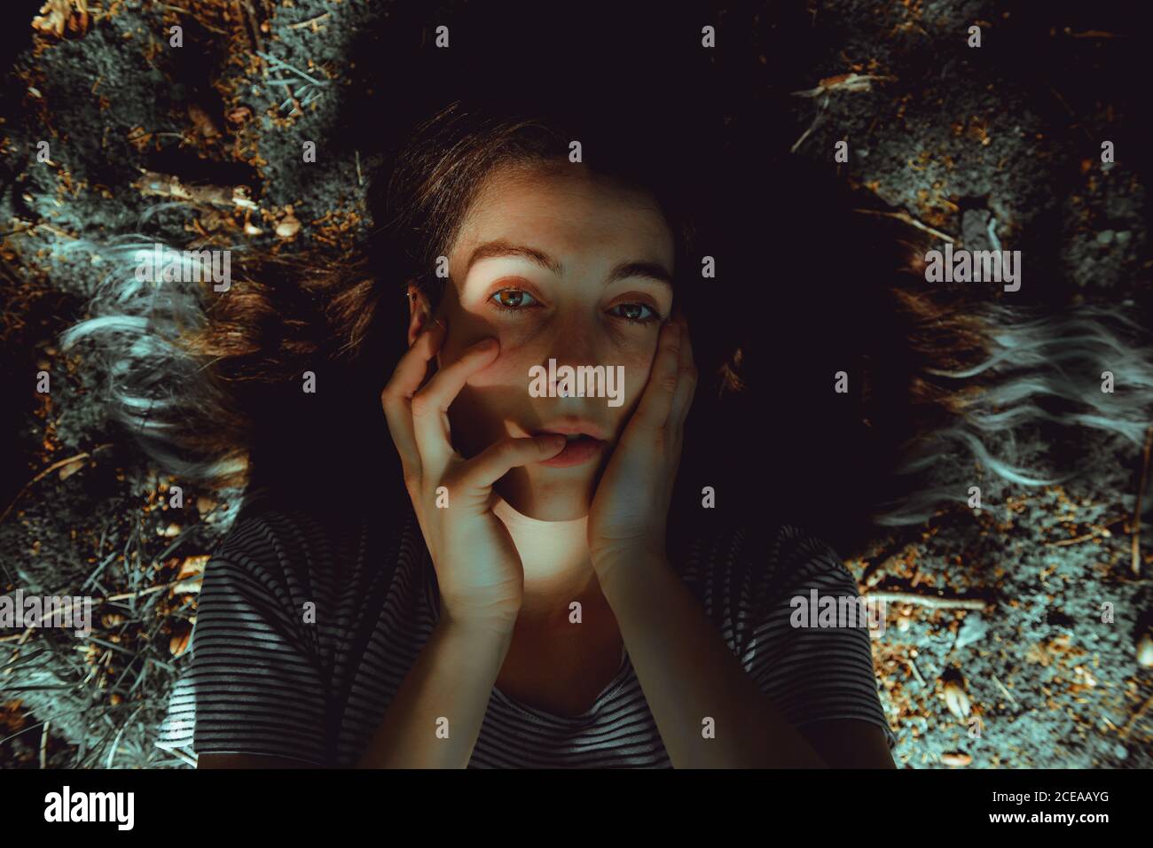 Woman lying on ground Stock Photo - Alamy