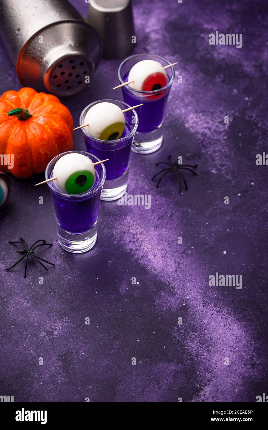 Halloween purple cocktail with eyes Stock Photo - Alamy