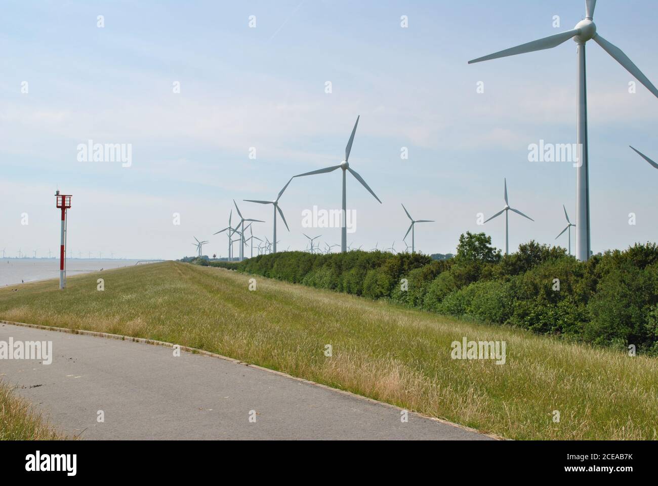 Giant wind turbines in the field under the blue sky Stock Photo - Alamy
