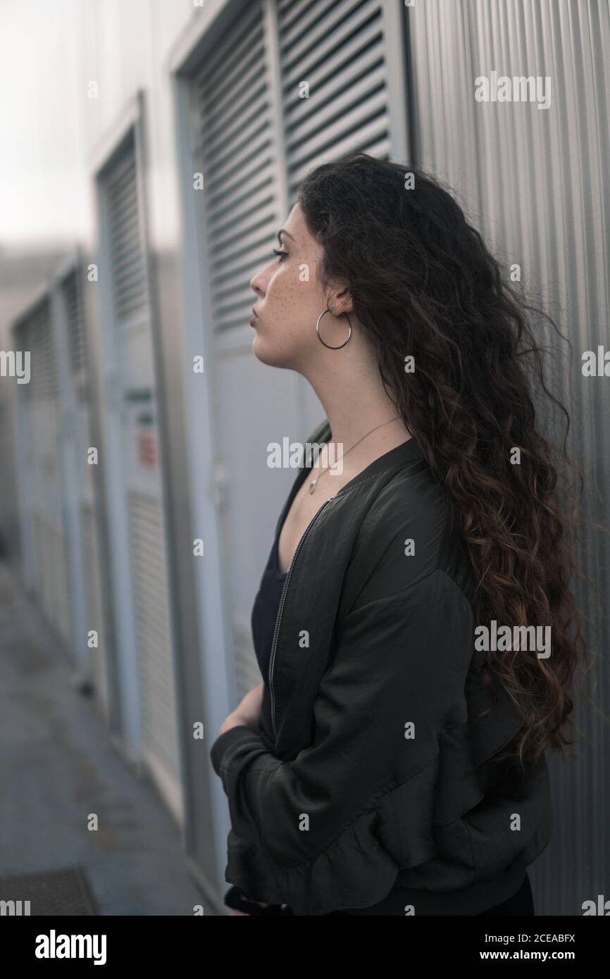 Young Woman leaning on wall Stock Photo - Alamy
