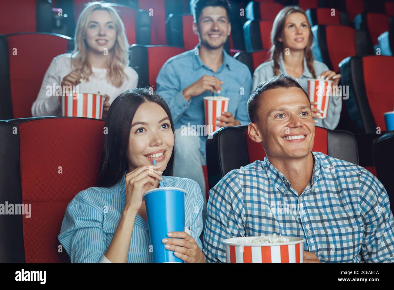 Young people friends together in the cinema Stock Photo - Alamy