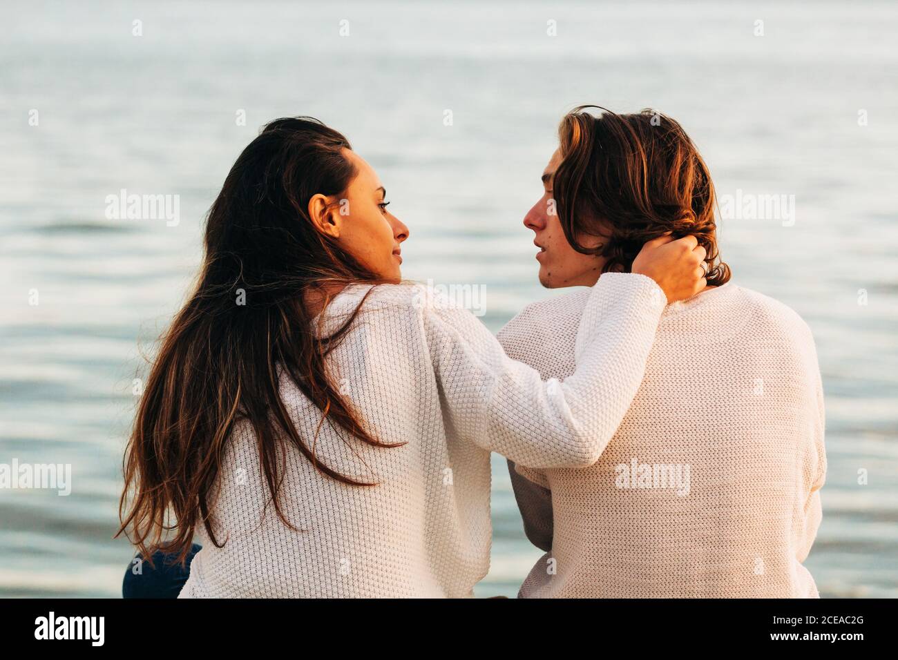 Back view lady hugging guy sweaters hi-res stock photography and images ...