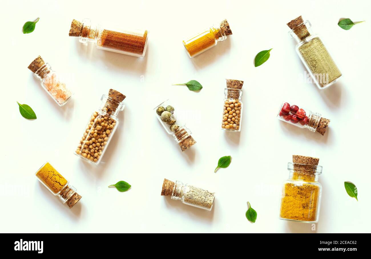 Spices in small bottles on white background Stock Photo - Alamy