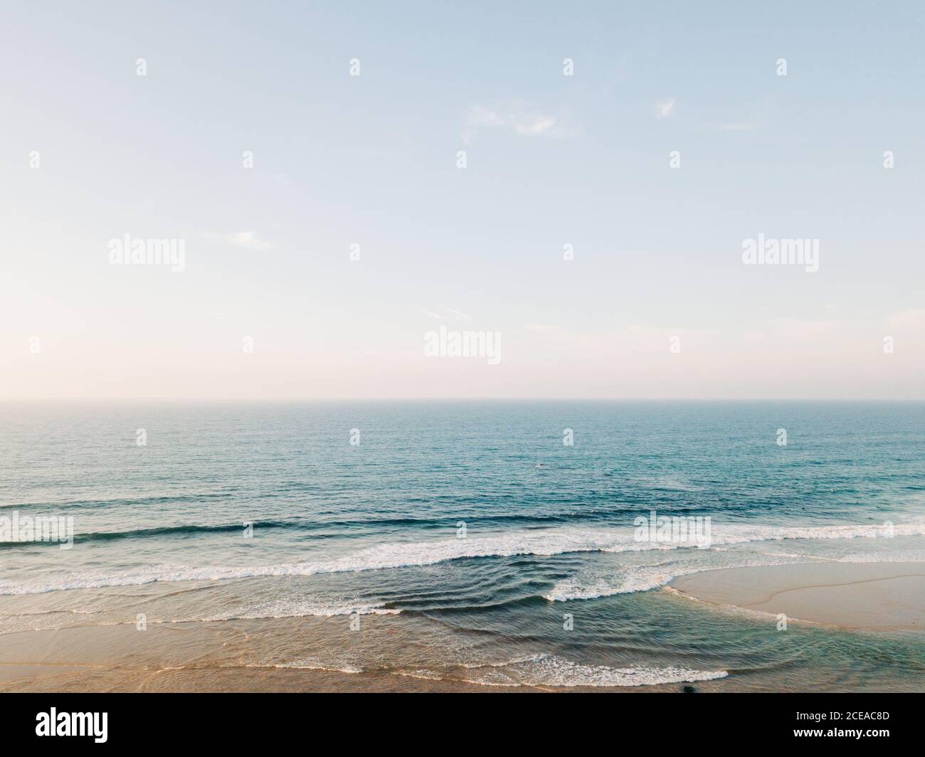 Seashore washed by water under sky Stock Photo - Alamy