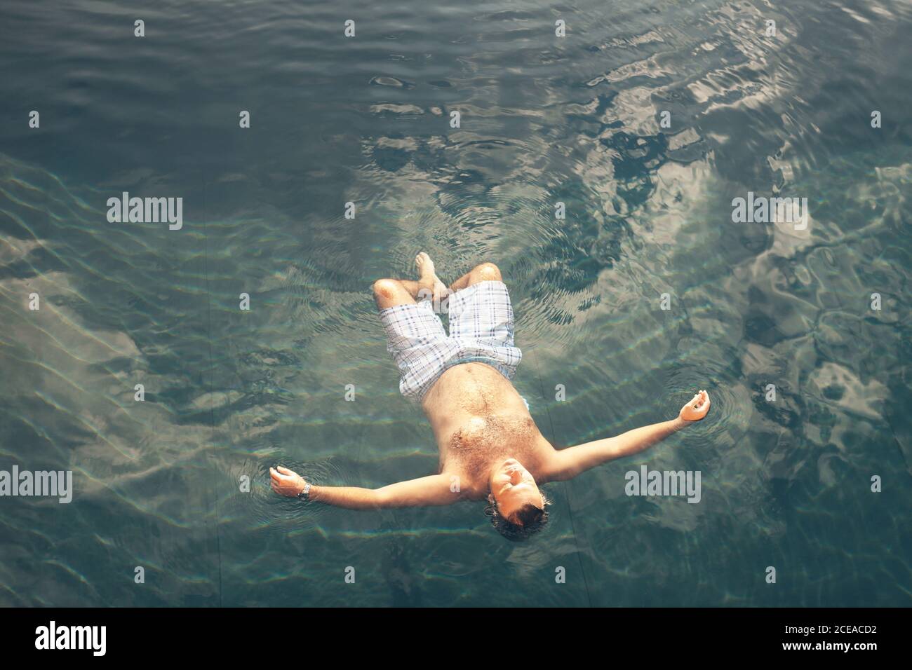 man swimming in blue water Stock Photo - Alamy