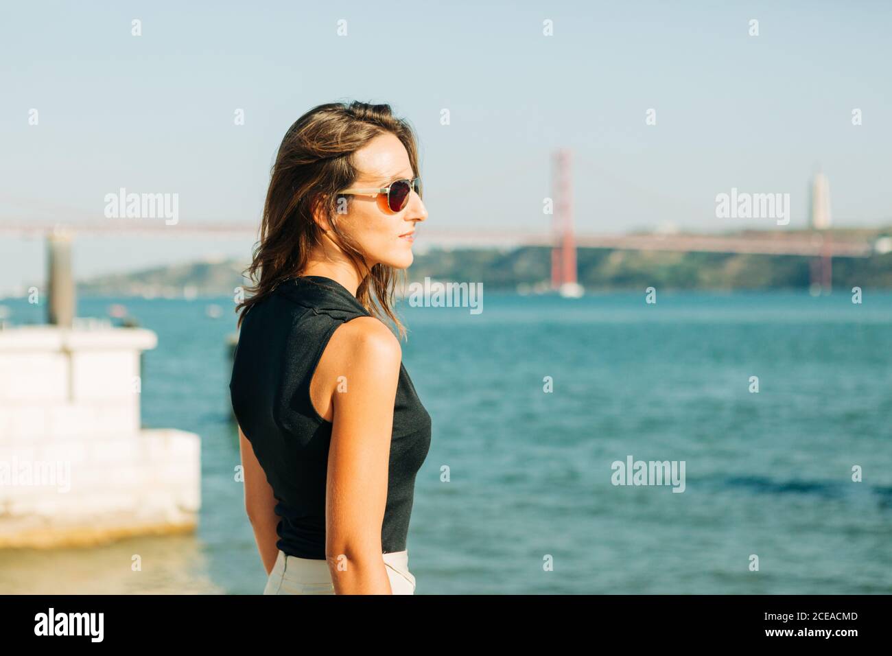 Trendy Woman at seafront with sailing boats on background Stock Photo ...
