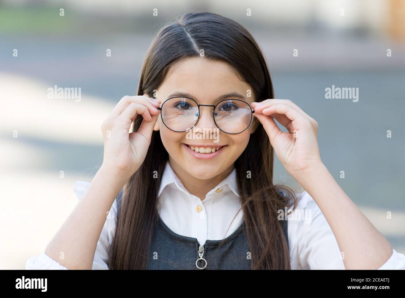 An intellectual look. Happy child look through glasses outdoors. Vision ...