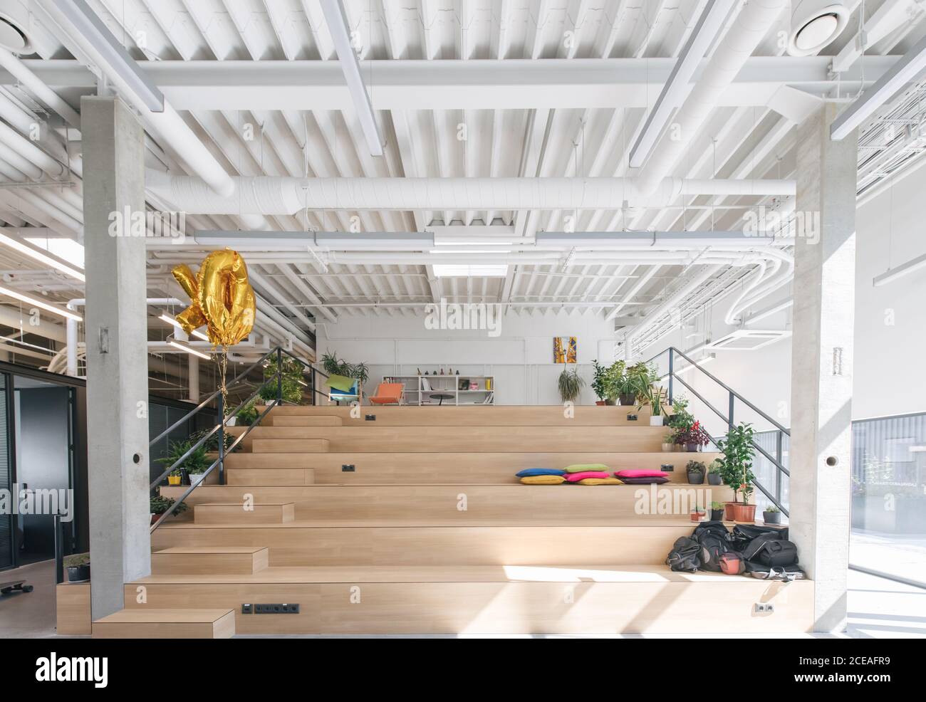Interior shot of modern office with wooden steps and place for rest and ...