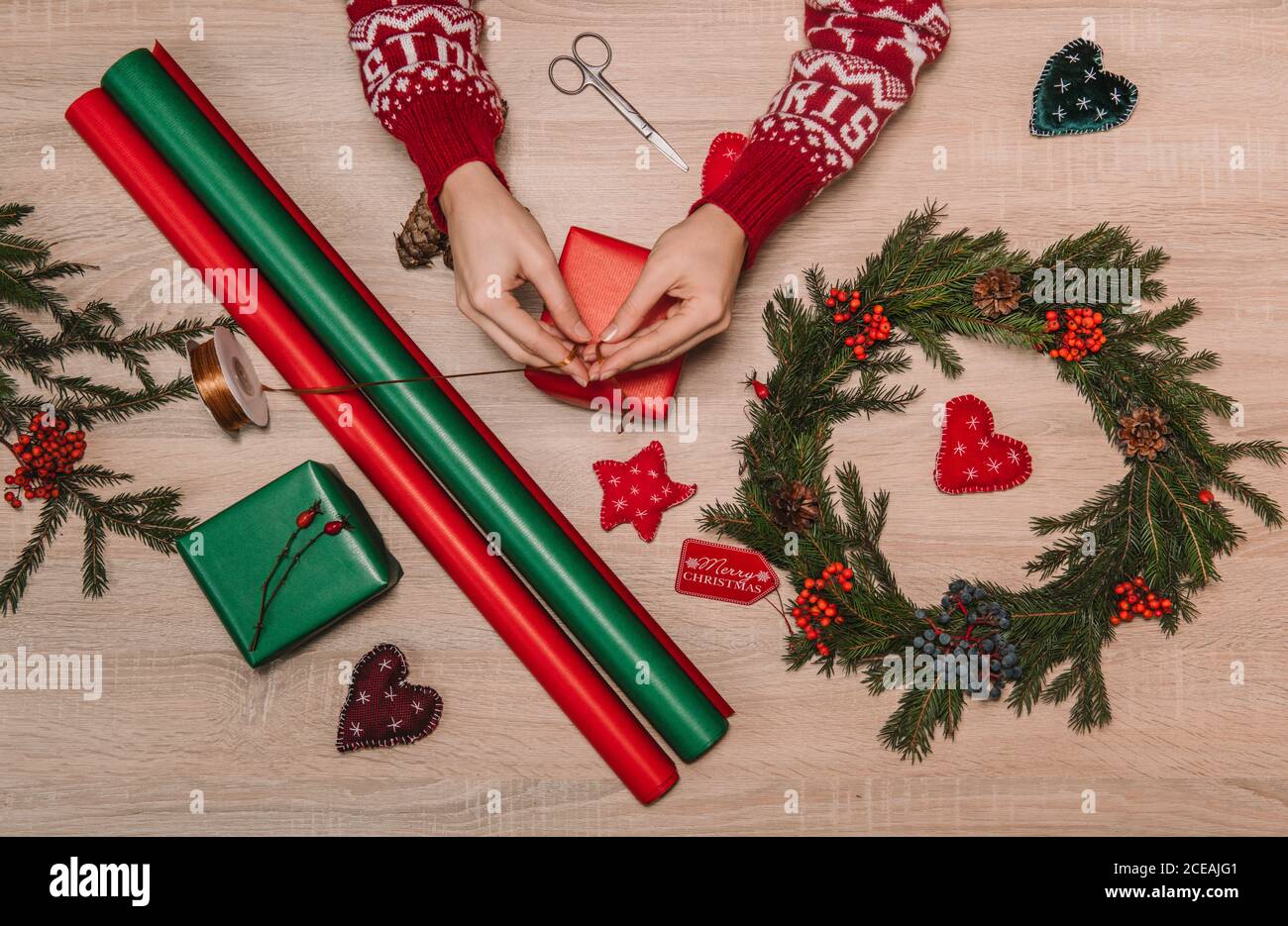 crop Woman tying a ribbon of a christmas gift surrender of decoration ...