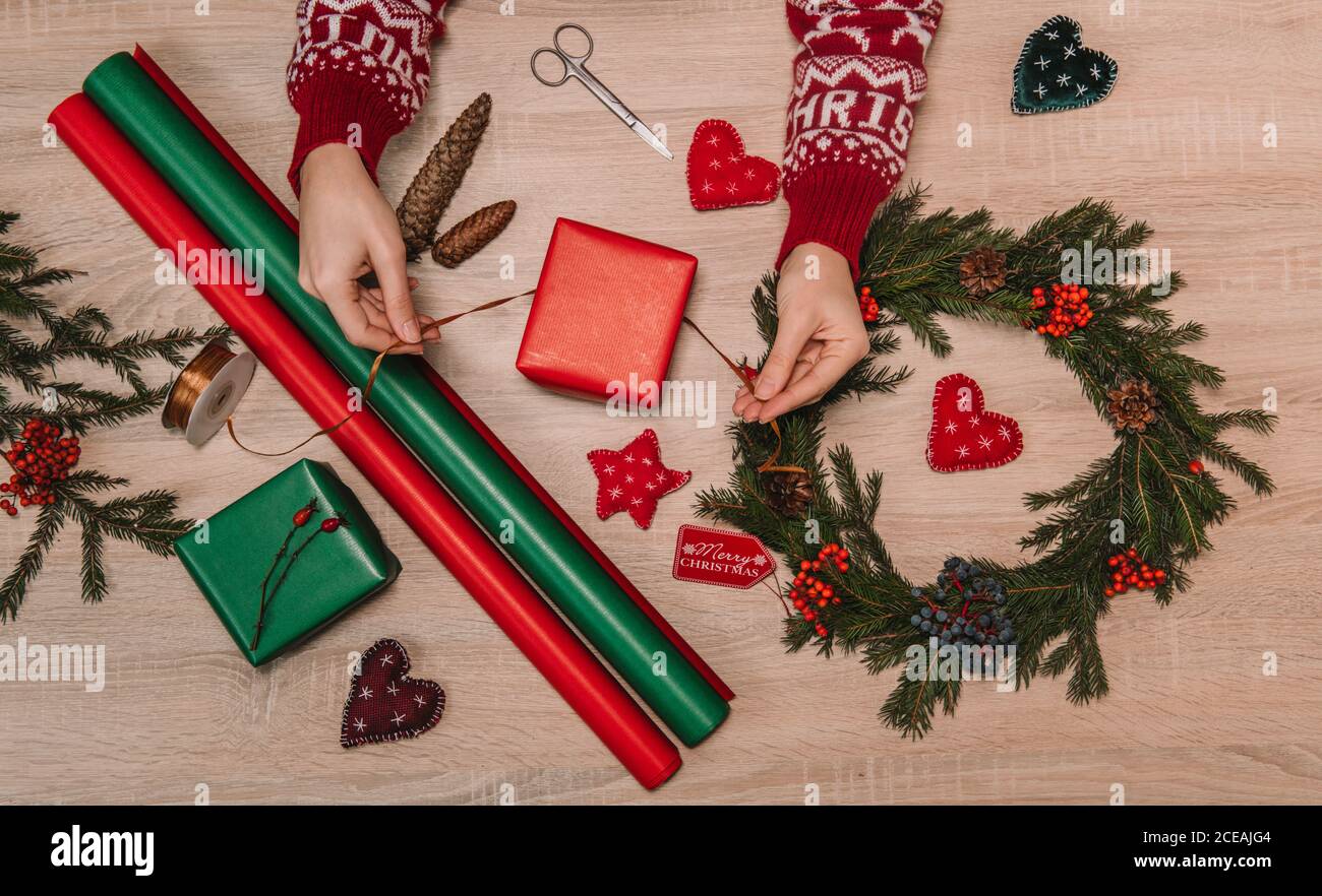 crop Woman tying a ribbon of a christmas gift surrender of decoration ...