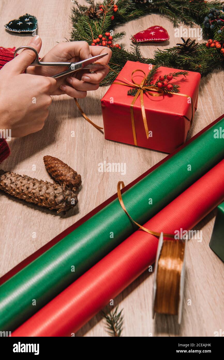 crop Woman tying a ribbon of a christmas gift surrender of decoration ...