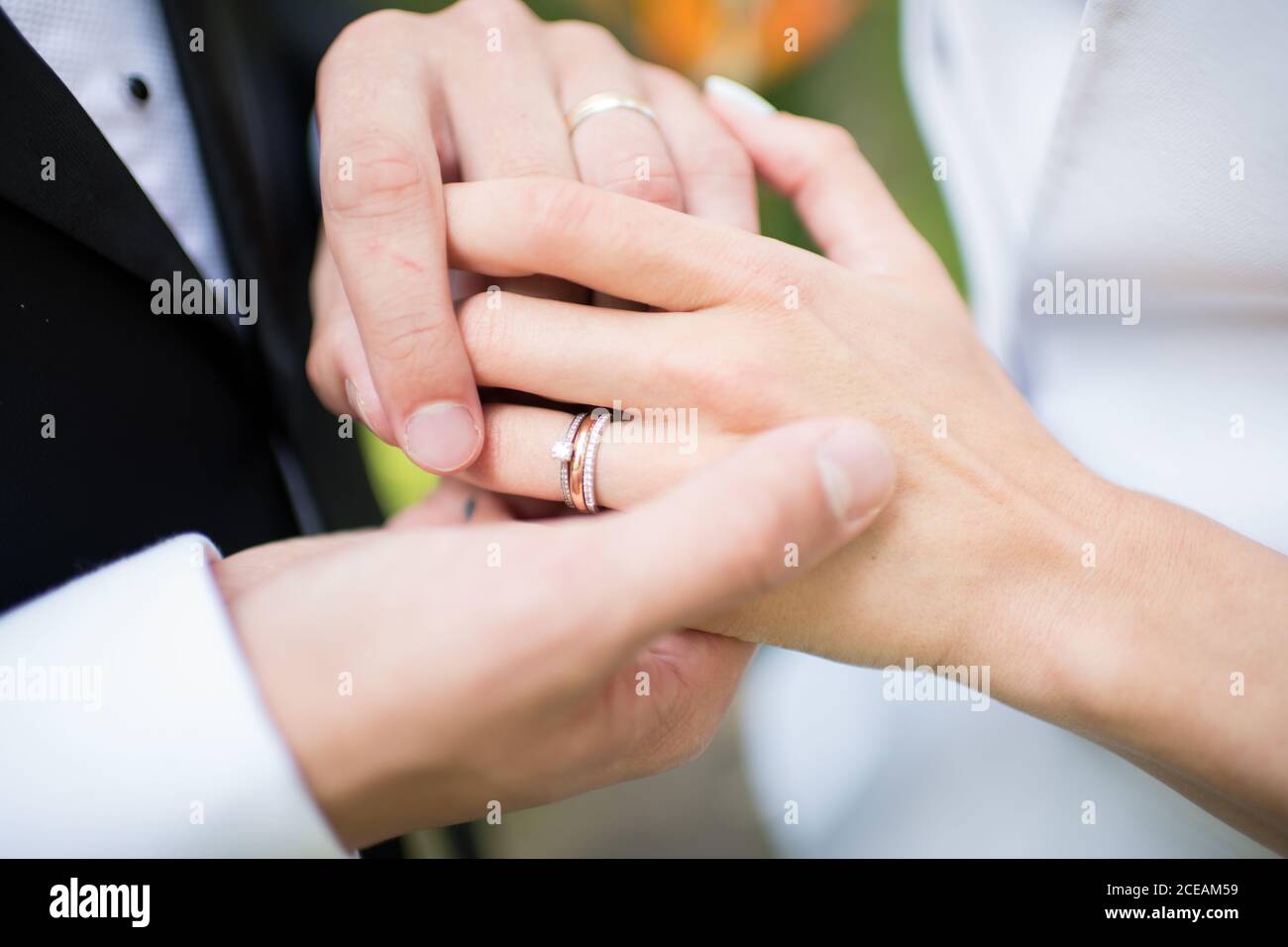 Putting wedding ring on finger during wedding ceremony hi-res stock ...
