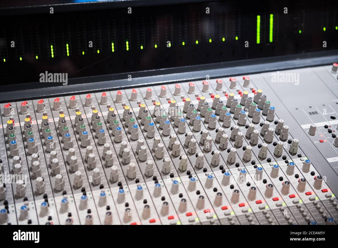 Close-up shot of switches on professional audio mixer board in ...