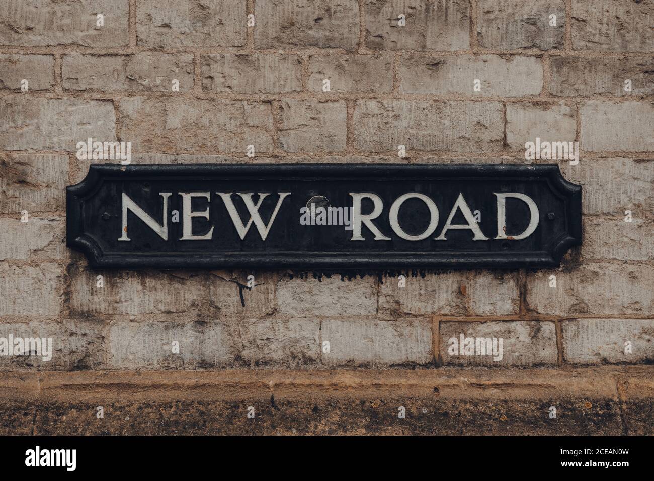 Metal street name sign on a wall of a building on New Road in Oxford ...