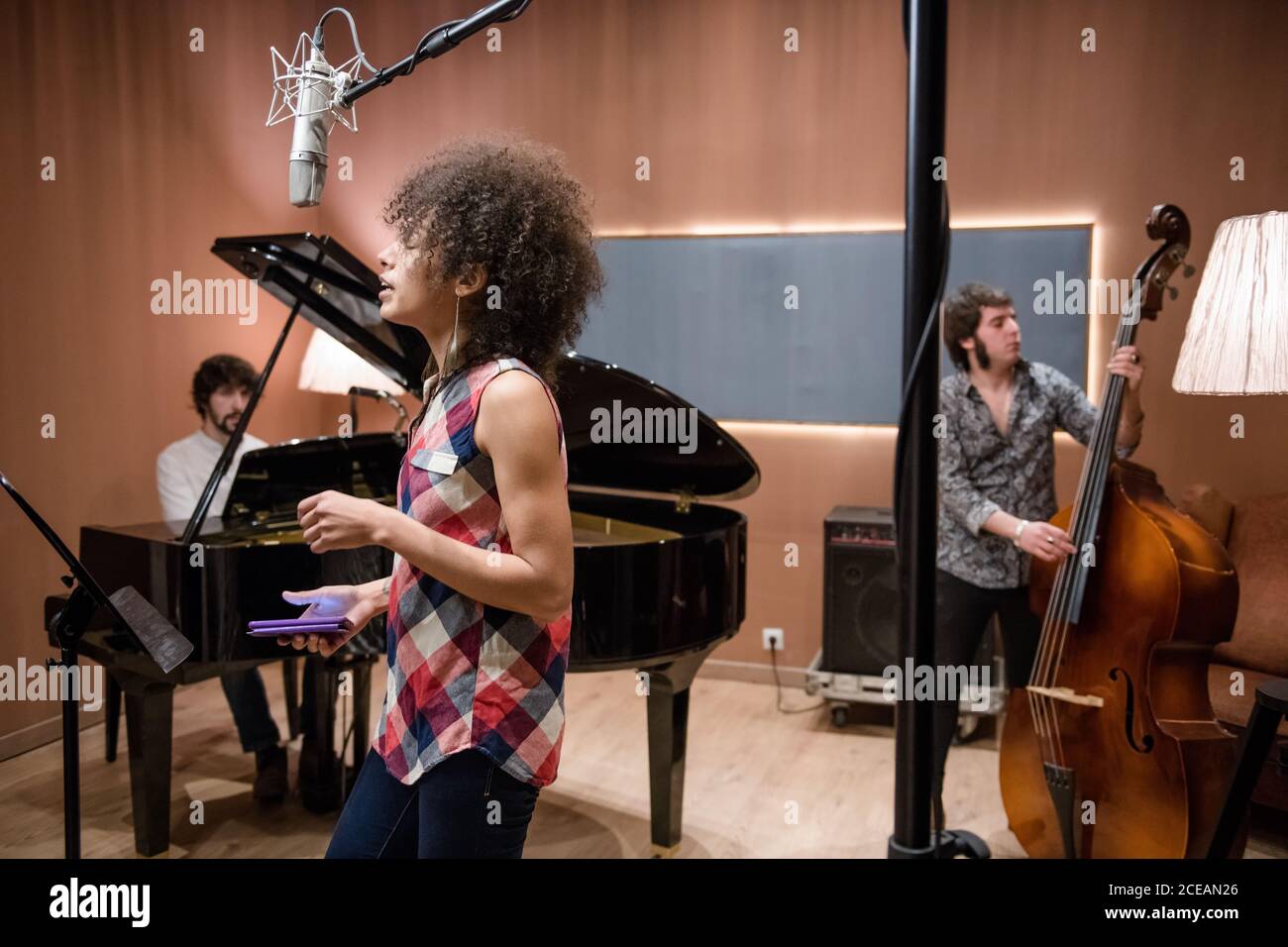 Lovely Woman in casual outfit singing nice song white rehearsing with ...