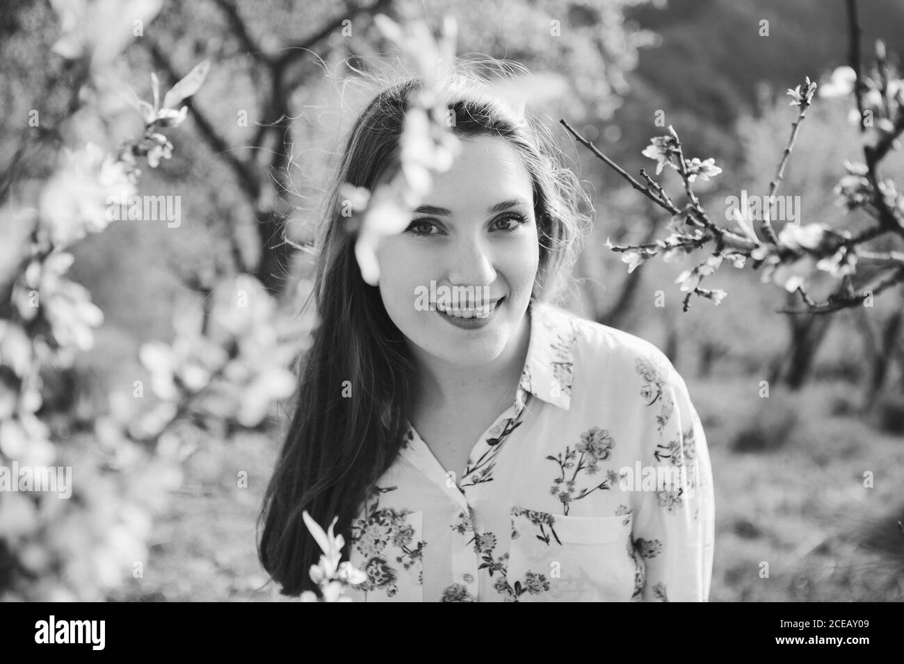 High angle side view of crop anonymous barefoot female standing on dark ...