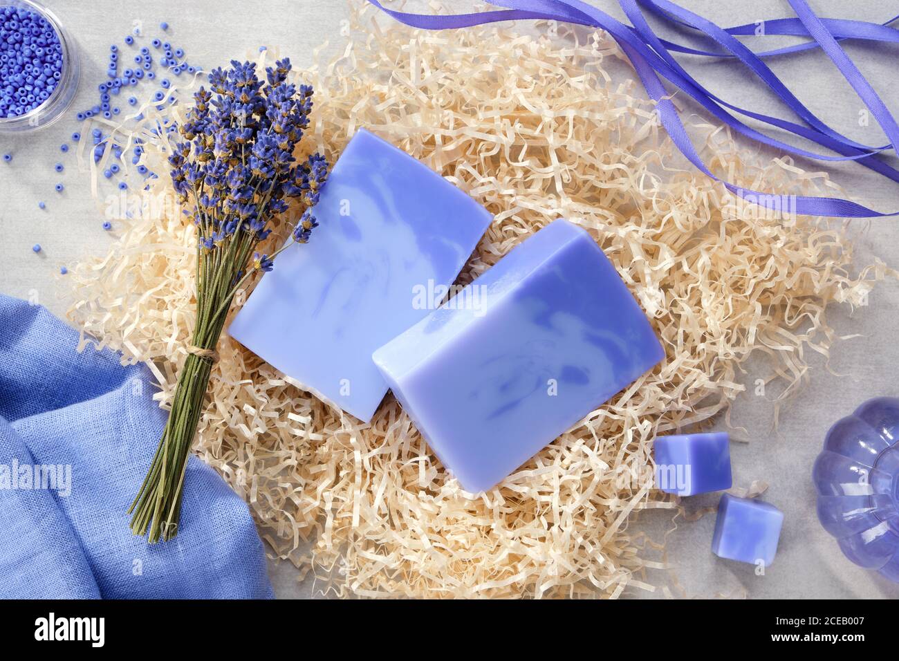 Two homemade lavender soap bars, lavender extract bottle and dry ...