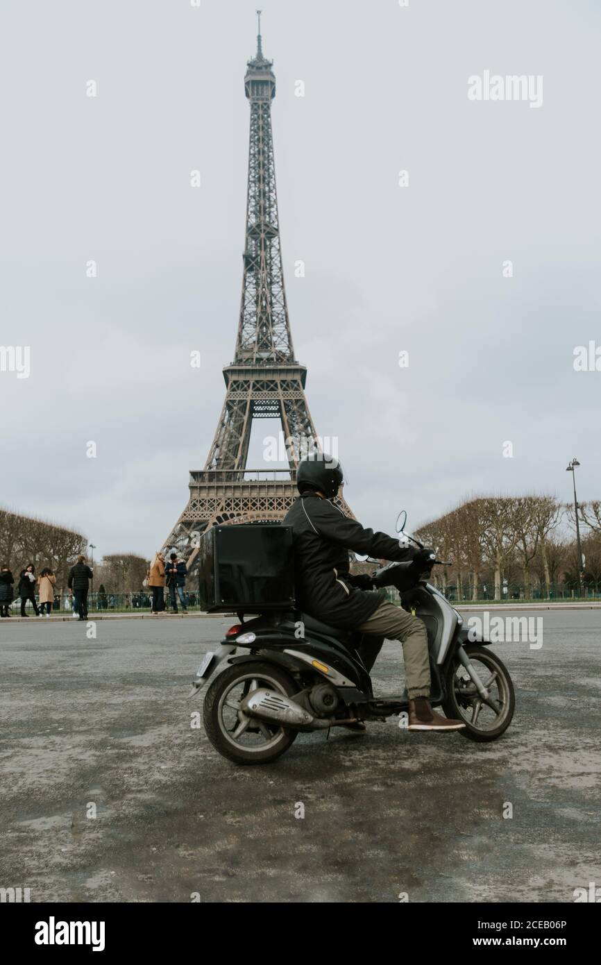 Side view tourist riding scooter at eiffel tower paris hi-res stock ...
