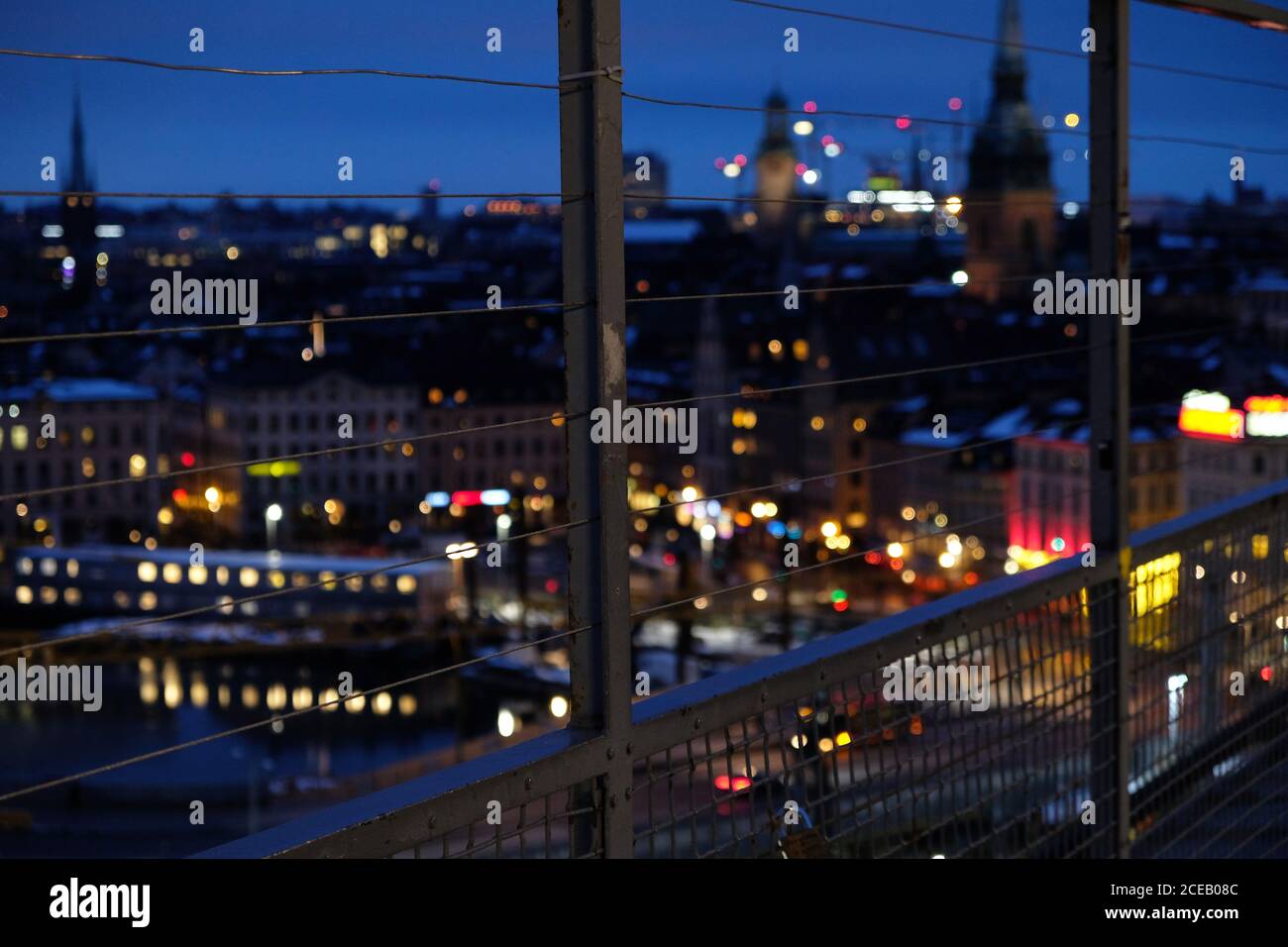 Amazing view of beautiful evening city from behind of fence with metal ...