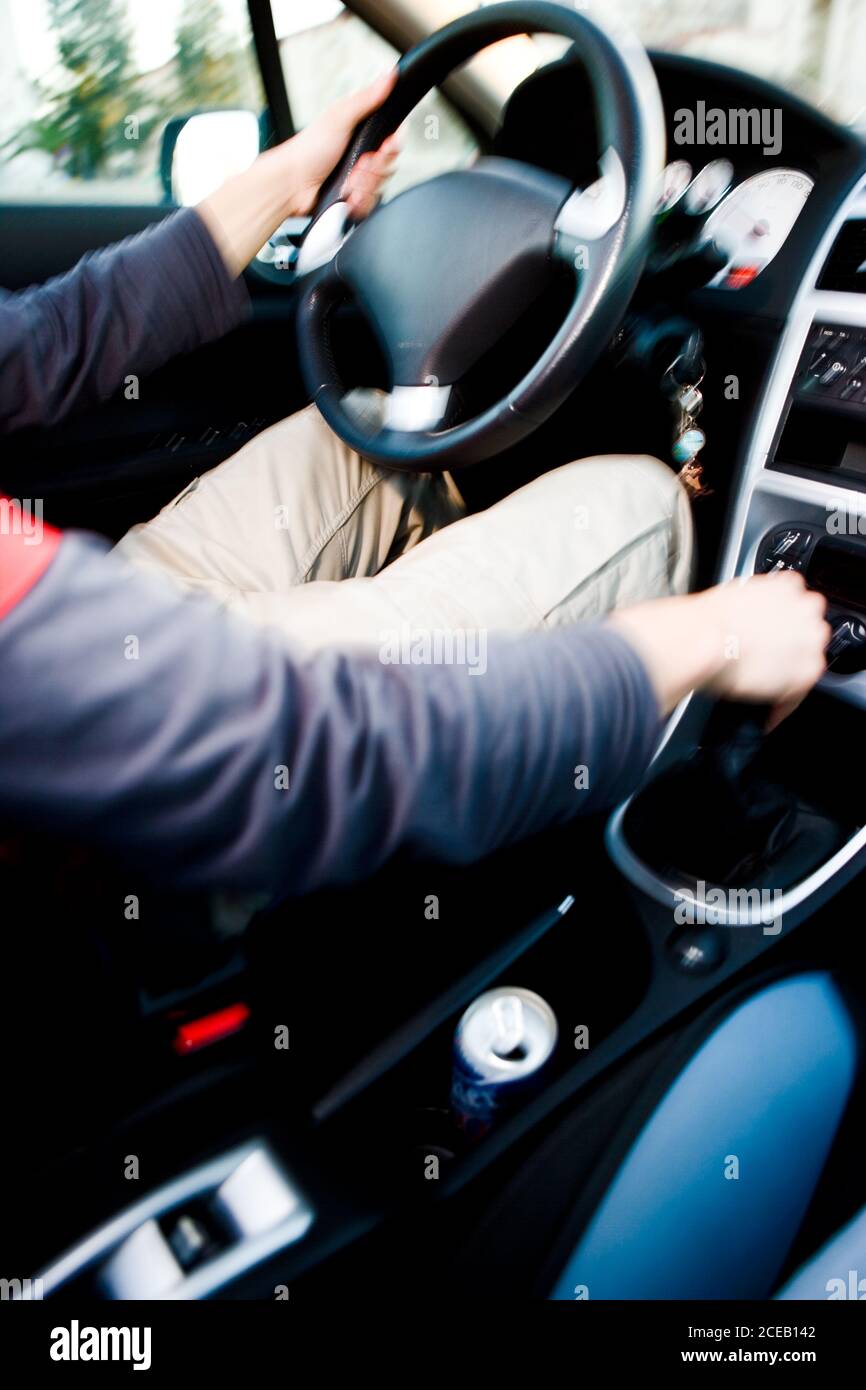 Crop shot of man holding hands on steering wheel and driving car on ...