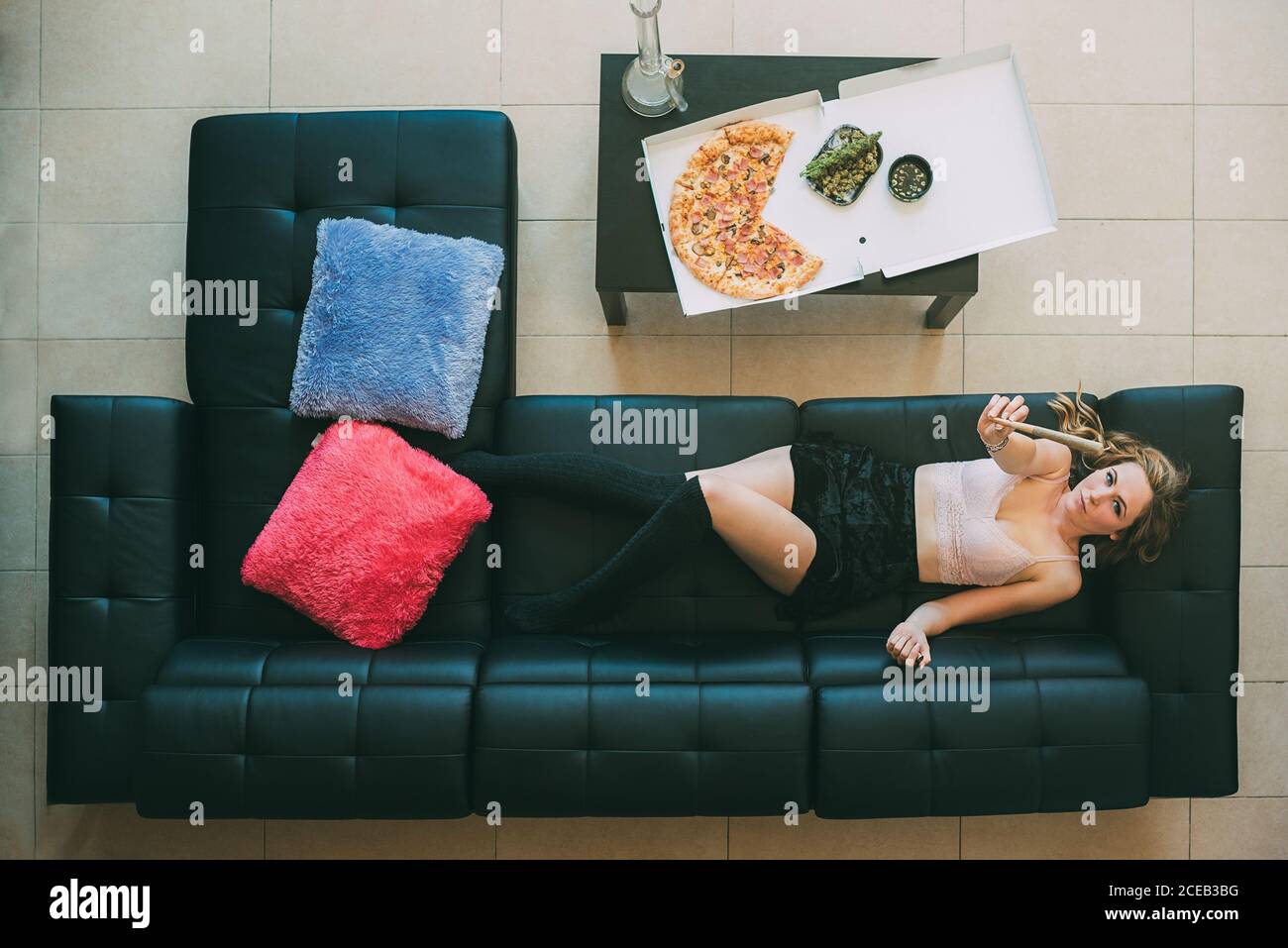 Woman lying on sofa with marijuana joint Stock Photo - Alamy