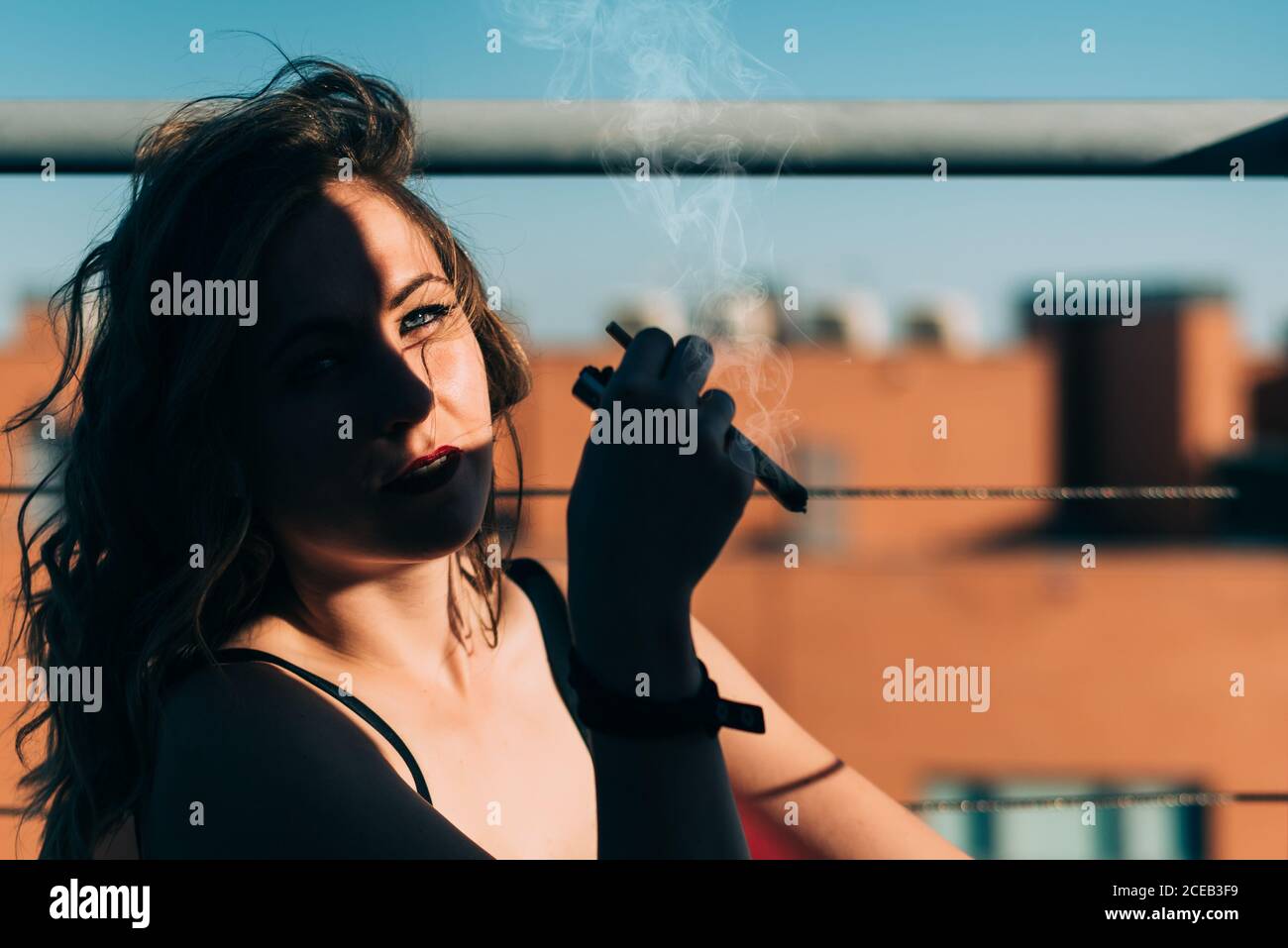 Young Woman smoking a cannabis joint Stock Photo - Alamy