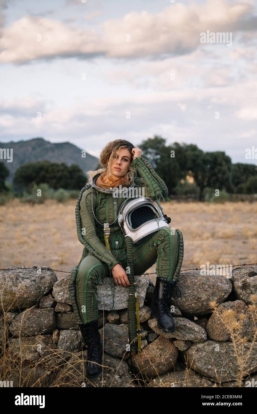 Beautiful Woman posing dressed as an astronaut Stock Photo - Alamy