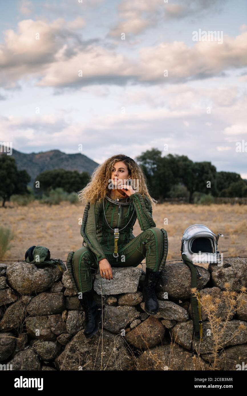 Beautiful Woman posing dressed as an astronaut Stock Photo - Alamy