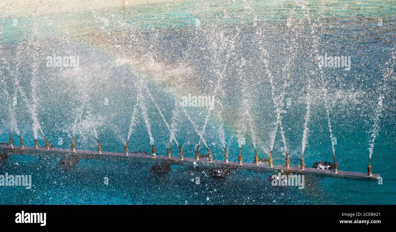 A water fountain sprinkling water in the view Stock Photo - Alamy