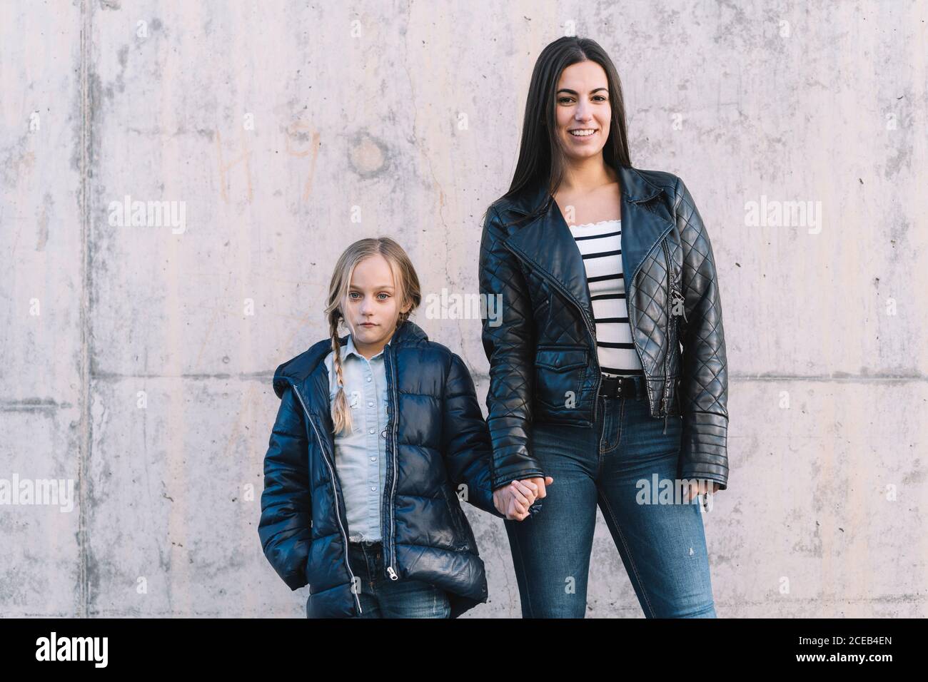Young sisters holding hands Stock Photo - Alamy