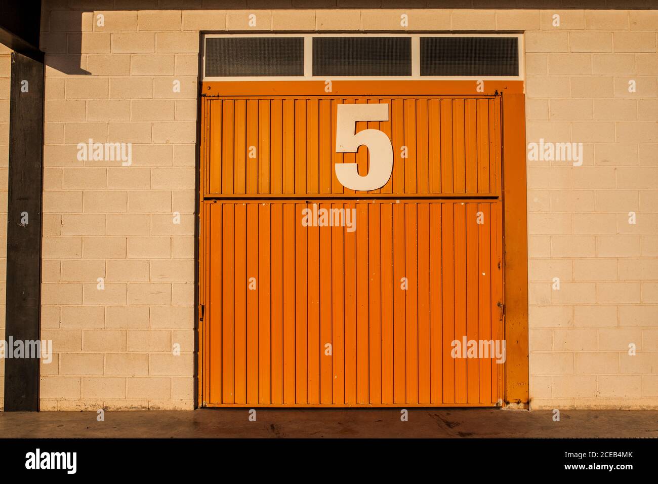 Garage door with number five Stock Photo - Alamy