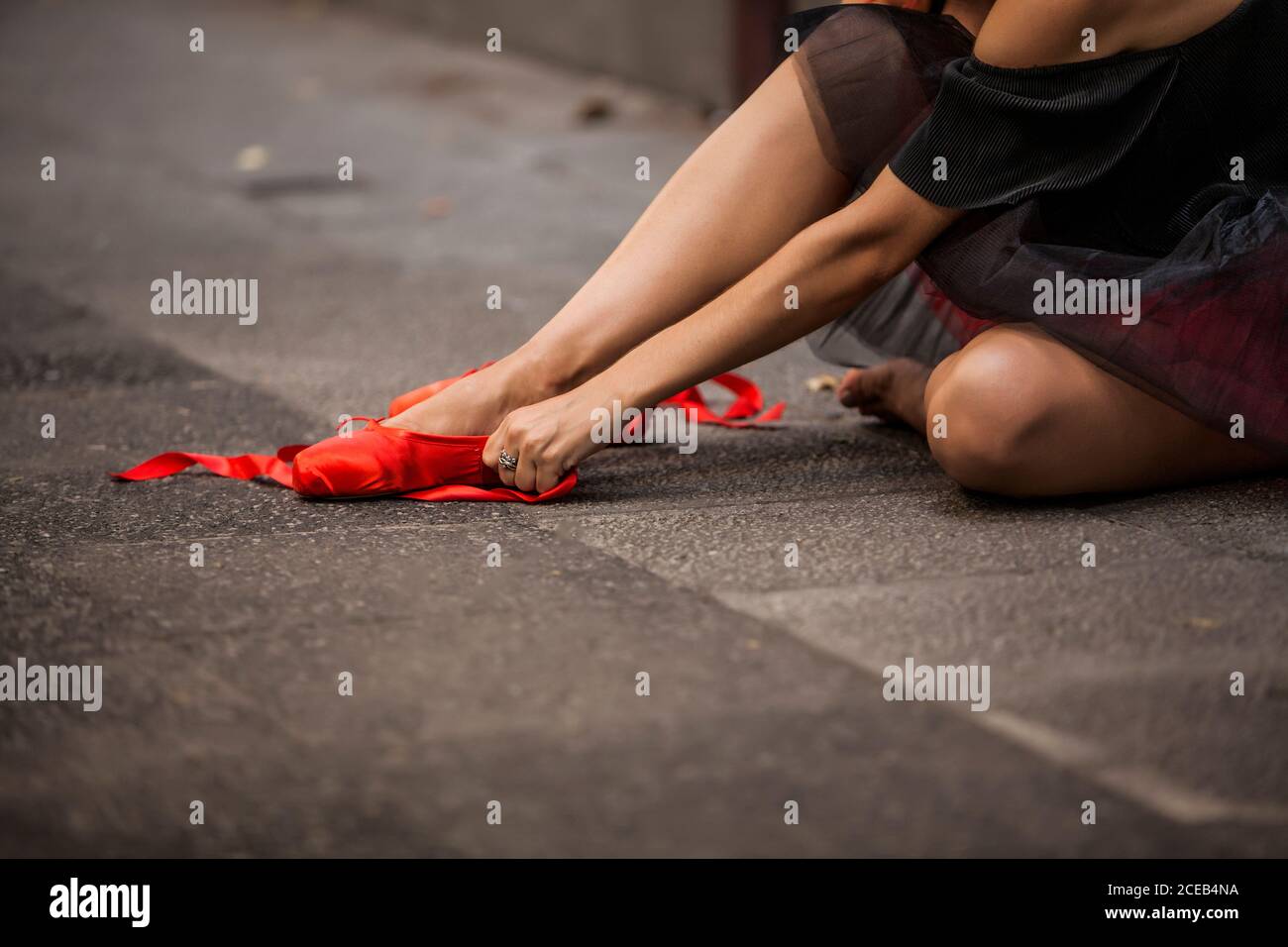 Red head ballerina with black tutu squashing red ballet tips on the ...