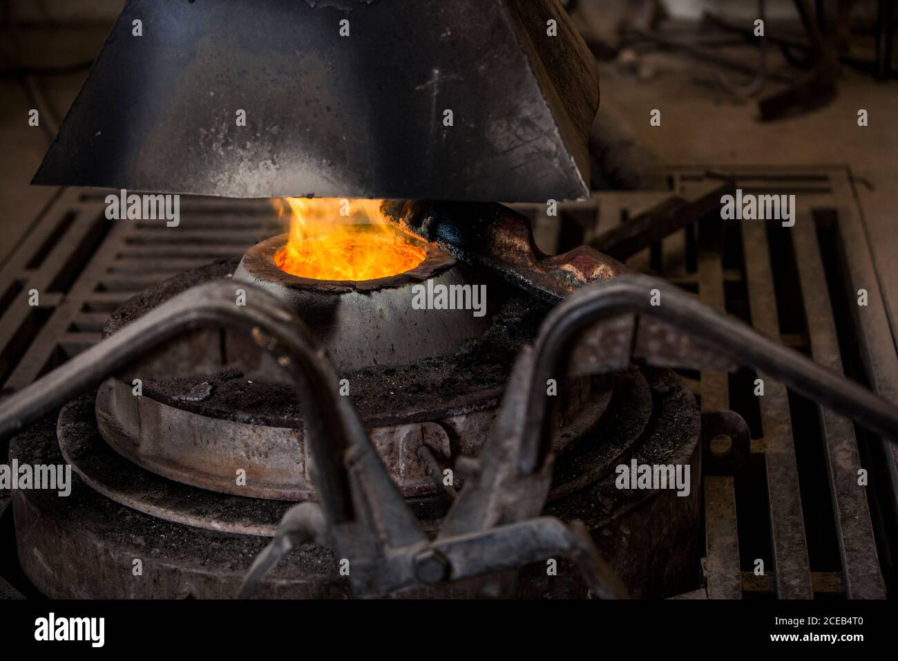 Crop view of blacksmith furnace with a burning fire in metal casting ...