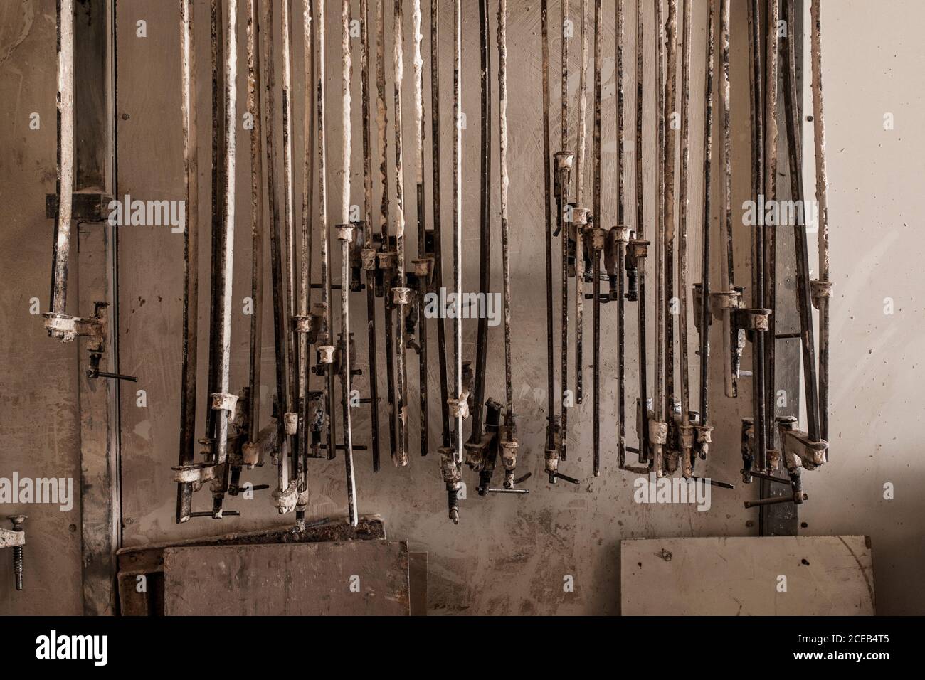 Crop view of steel instruments hanging in casting factory Stock Photo ...