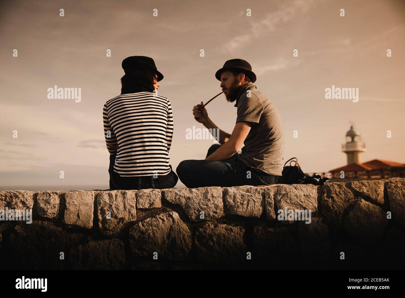 Man sitting smoking pipe woman hi-res stock photography and images - Alamy