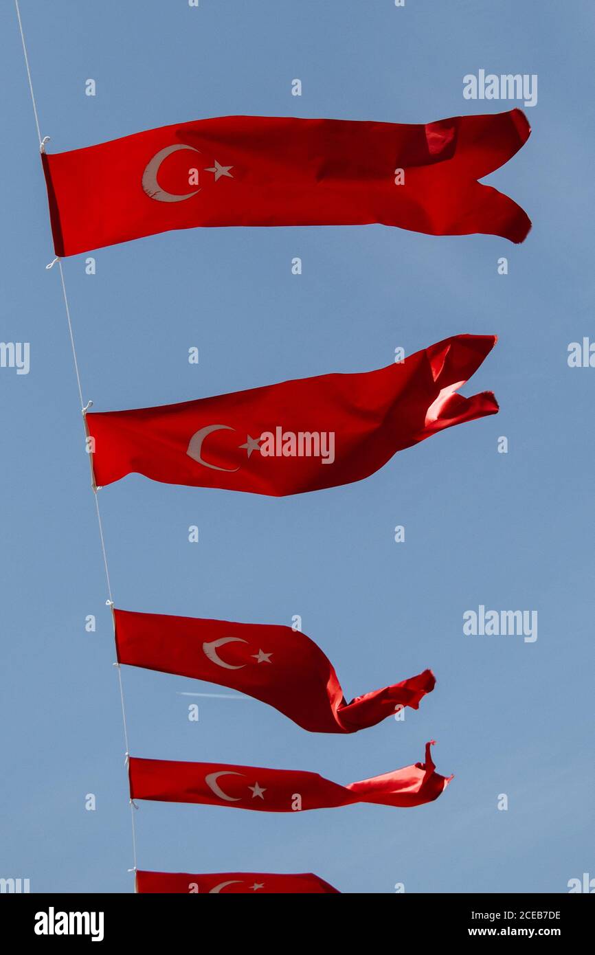Turkish national flags with white star and moon in sky Stock Photo - Alamy