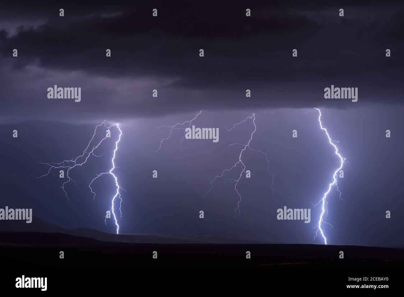 Dramatic night sky with lightning bolts strike from a thunderstorm in ...
