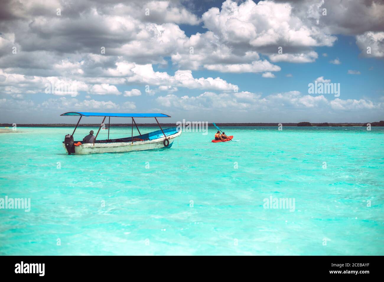 People riding boats while resting on resort on magnificent Caribbean ...